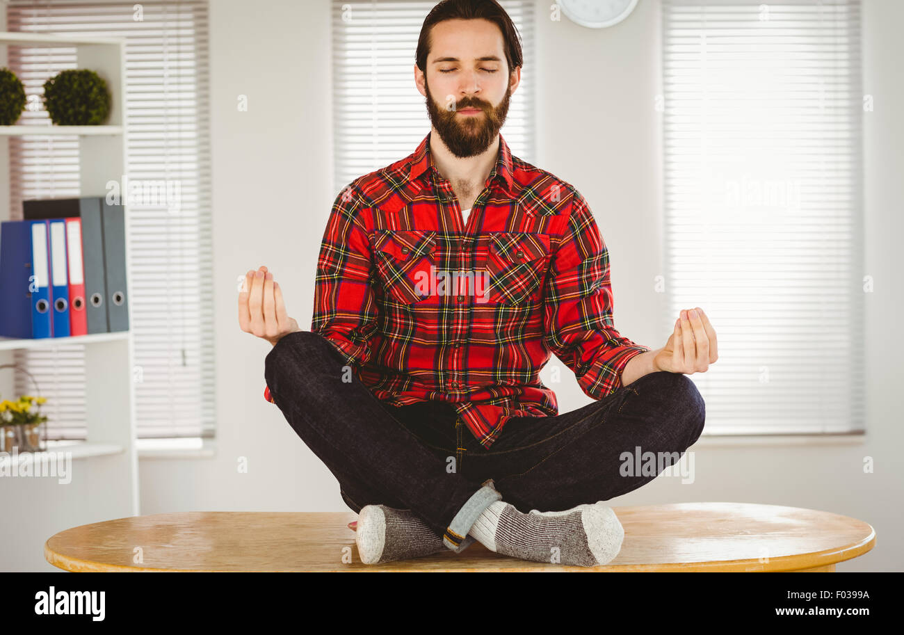 Hipster businessman meditating at his desk Stock Photo - Alamy