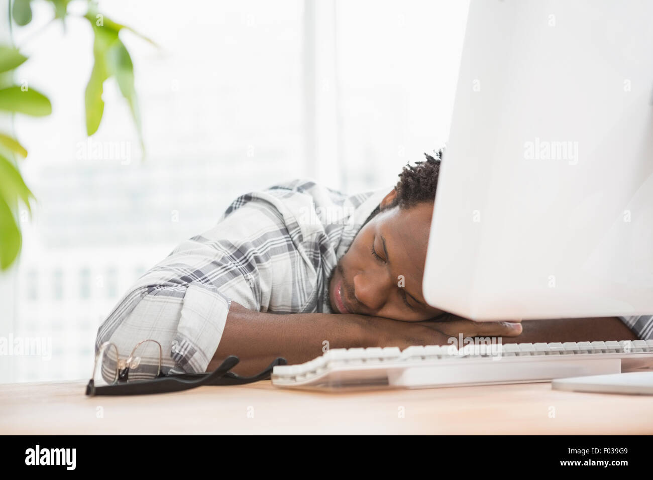 Tired casual businessman sleeping on keyboard Stock Photo - Alamy