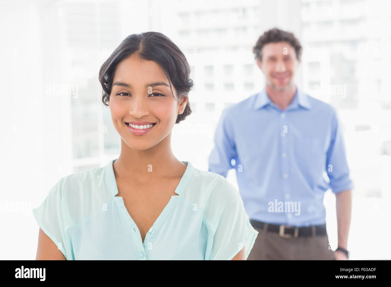 Casual business partners smiling at camera Stock Photo - Alamy