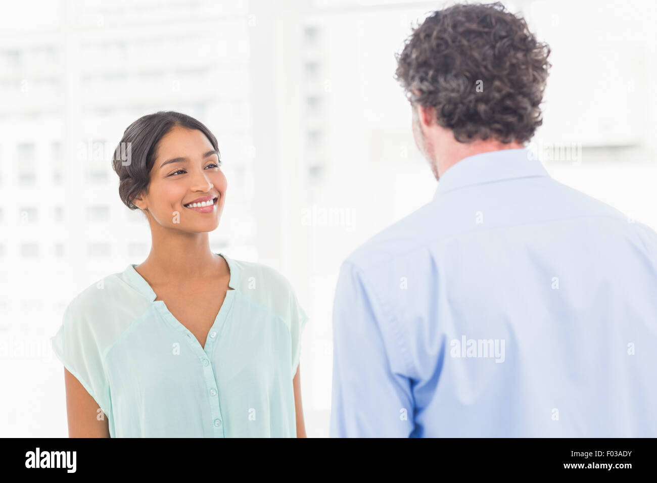 Casual business partners smiling Stock Photo - Alamy