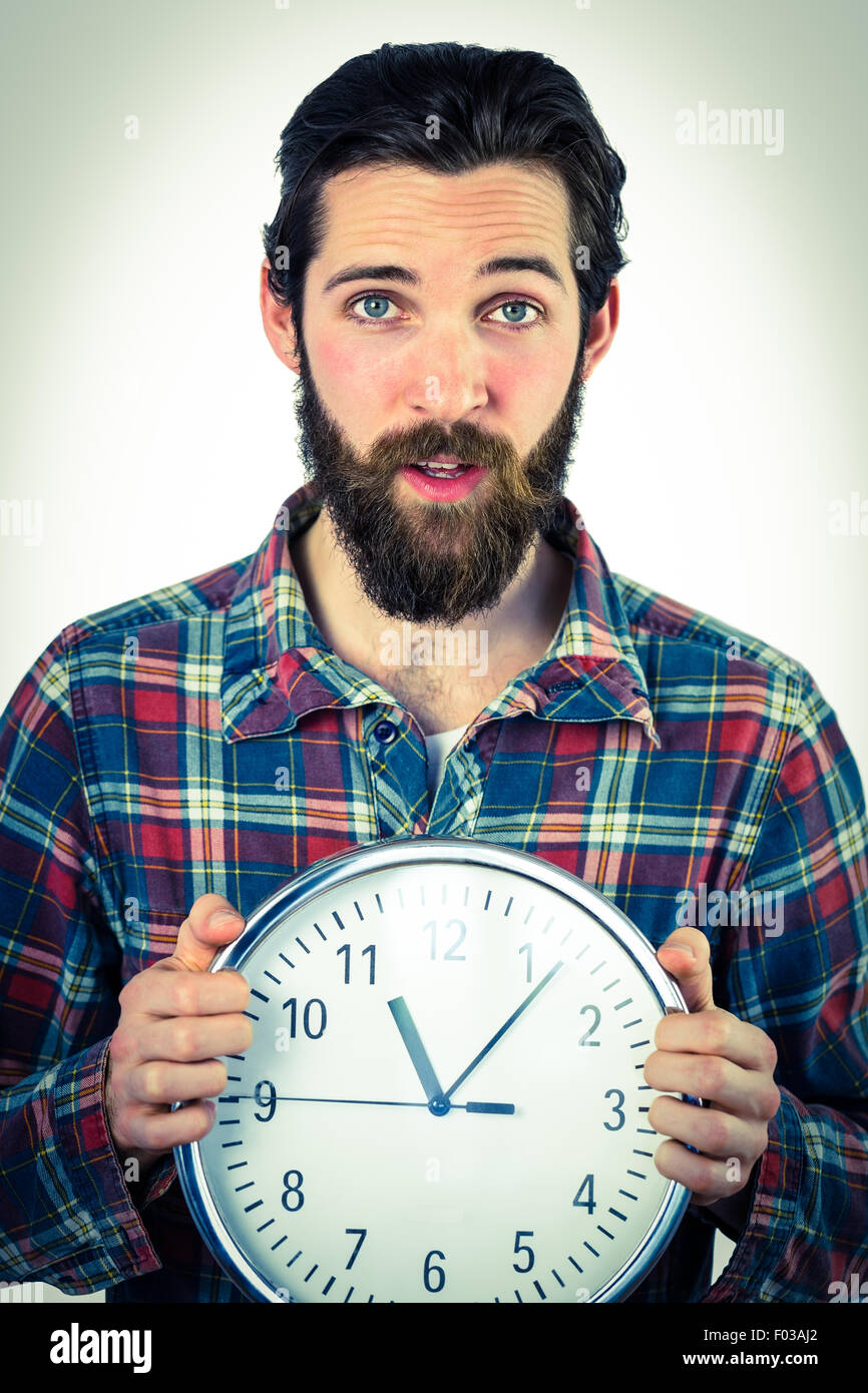 Handsome hipster showing a clock Stock Photo - Alamy