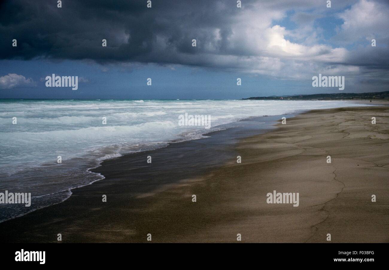 Dark clouds on the white beach of Rosignano Solvay, Tuscany region ...