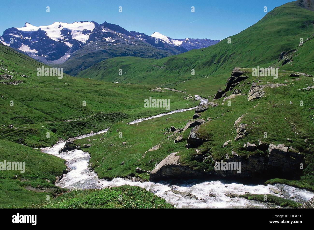 View from Col de l'Iseran, a stream and Mount Pourri in the background ...