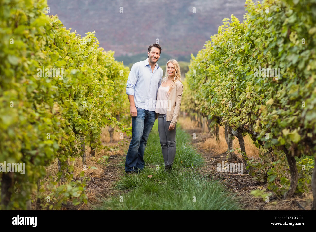 Young happy couple standing next to each other Stock Photo - Alamy