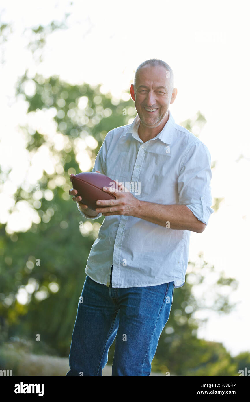 Elderly man playing american football in summer Stock Photo - Alamy
