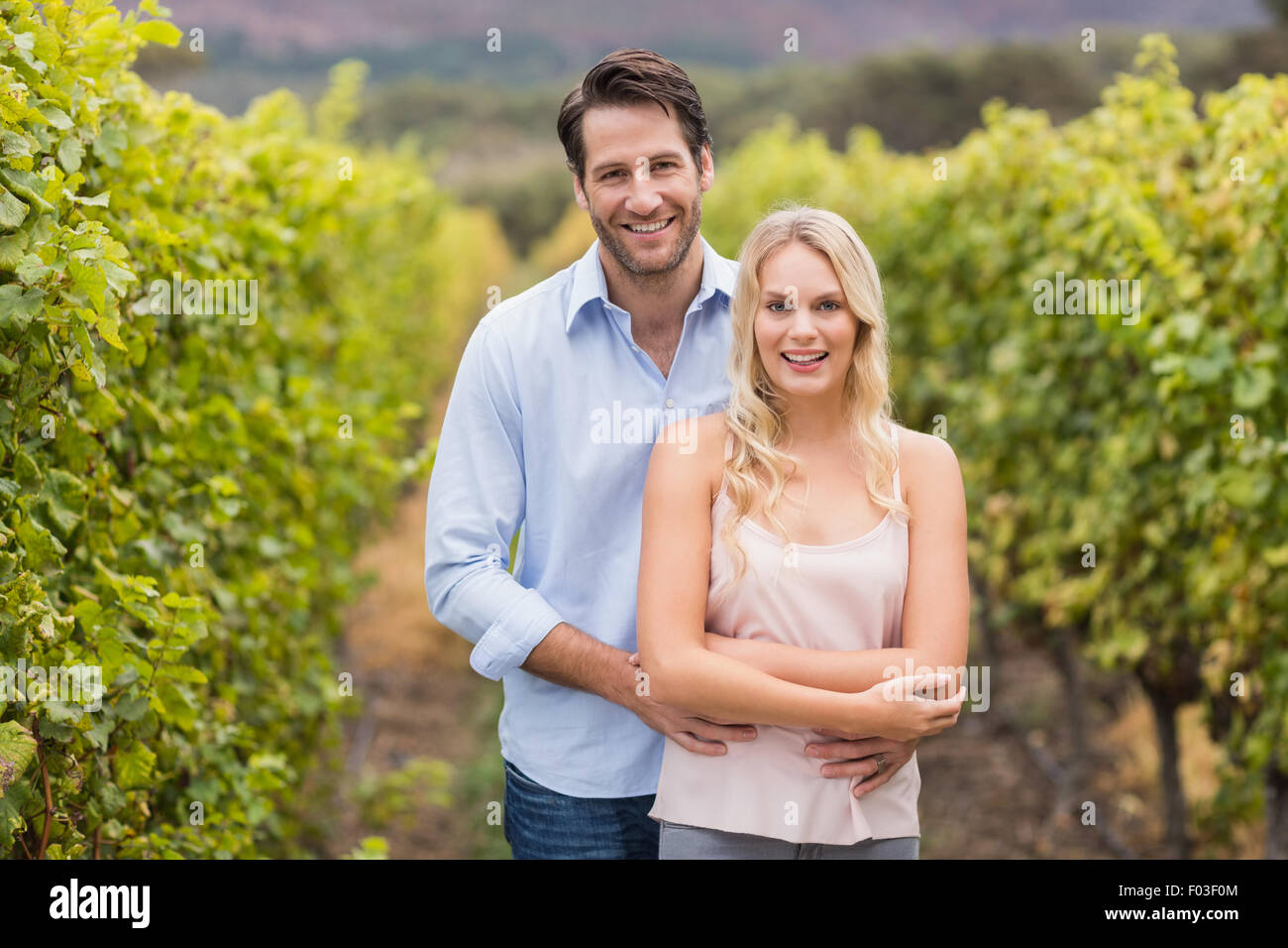 Young happy couple smiling at camera Stock Photo - Alamy