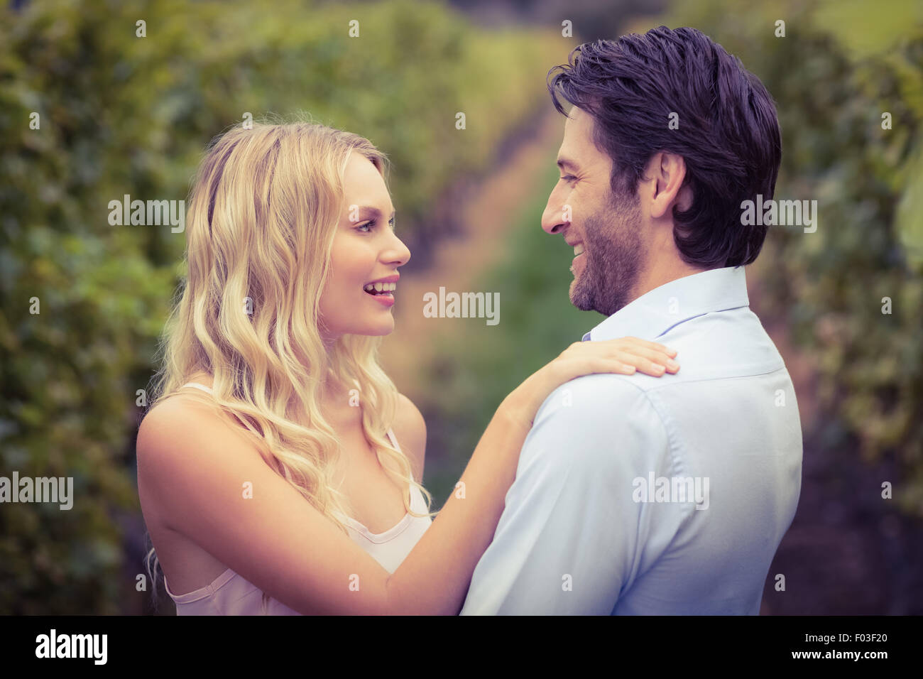 Young happy couple smiling at each other Stock Photo - Alamy