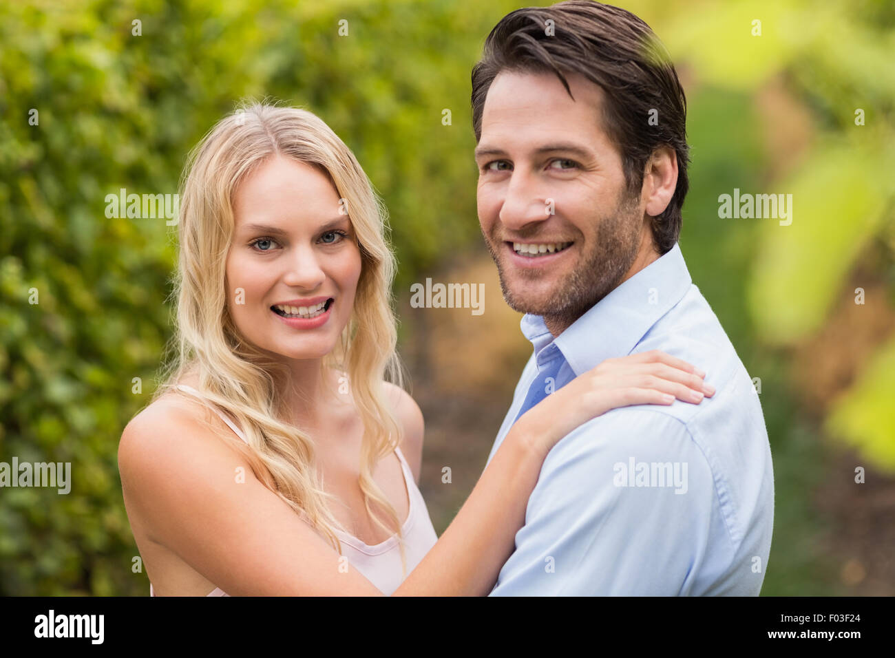 Young happy couple smiling at camera Stock Photo - Alamy
