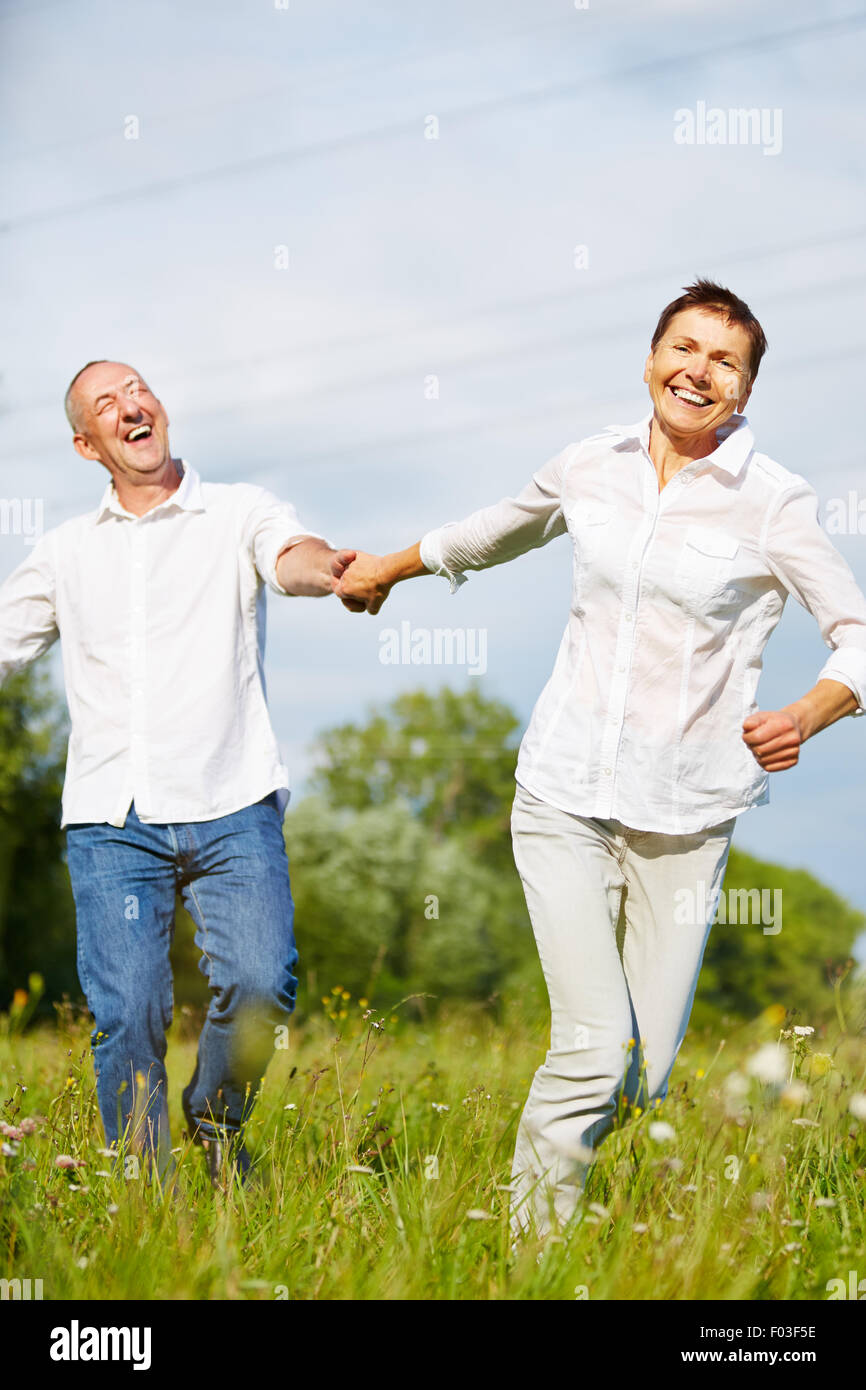 Couple running over a meadow hi-res stock photography and images - Alamy