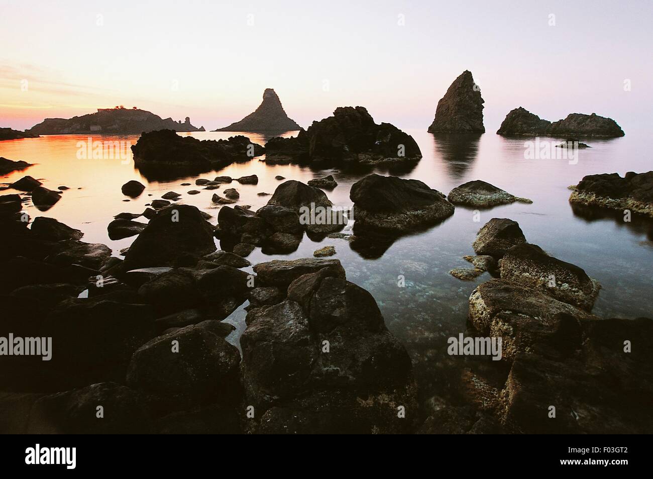 Sunrise on the basaltic columns, Cyclopean Isles, Aci Trezza, Sicily ...