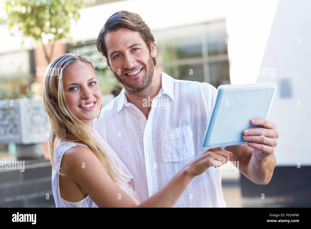 Smiling couple using tablet computer Stock Photo - Alamy