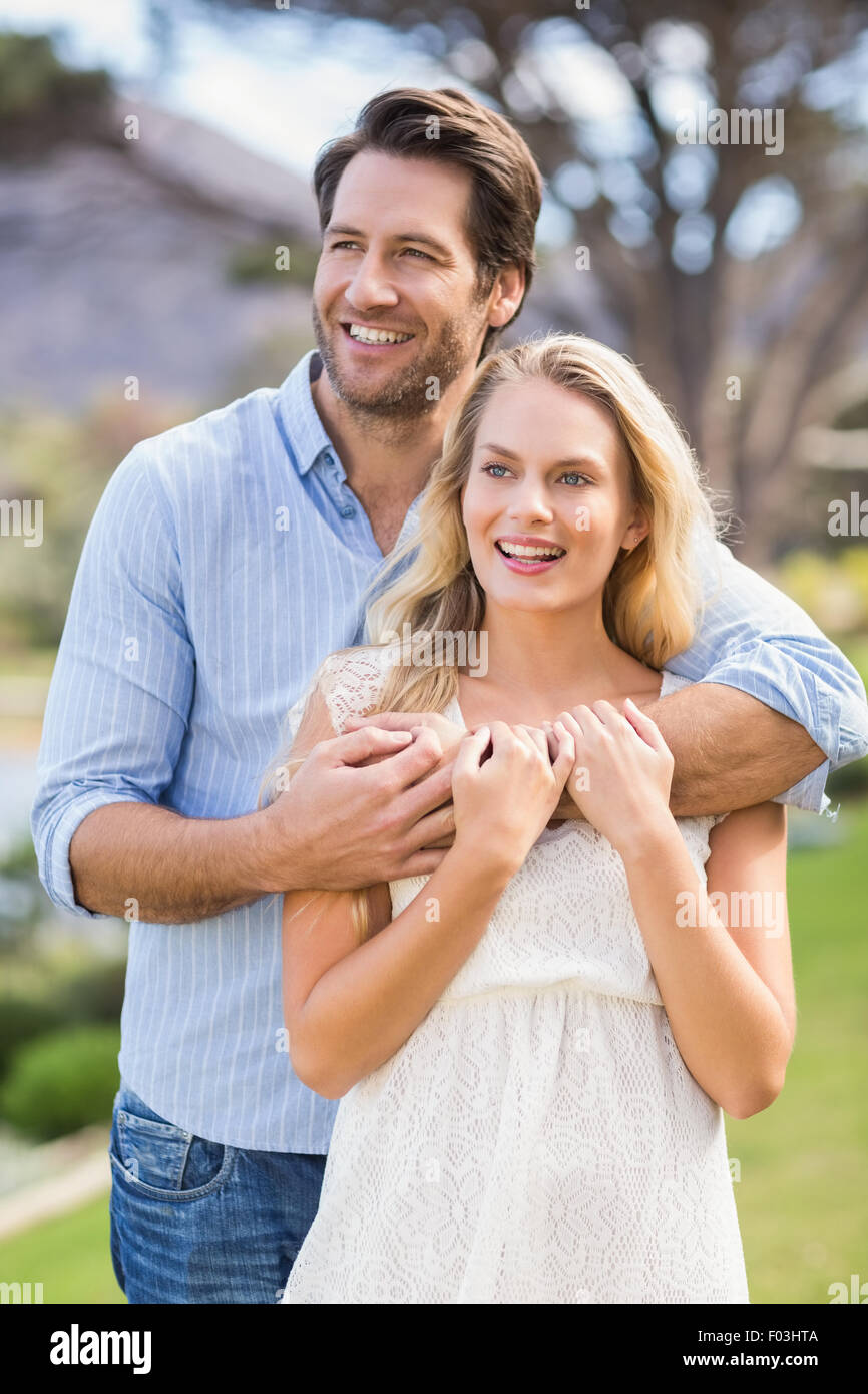 Cute couple on date with arms around Stock Photo - Alamy