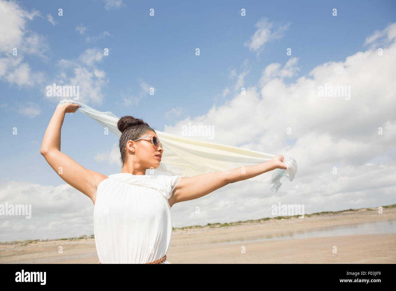 Stylish woman holding her scarf Stock Photo - Alamy
