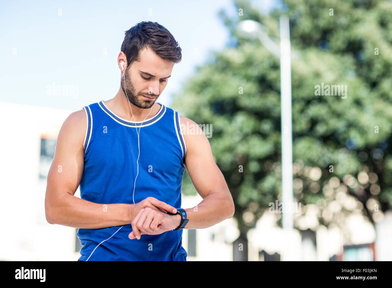 An handsome athlete using his phone Stock Photo - Alamy