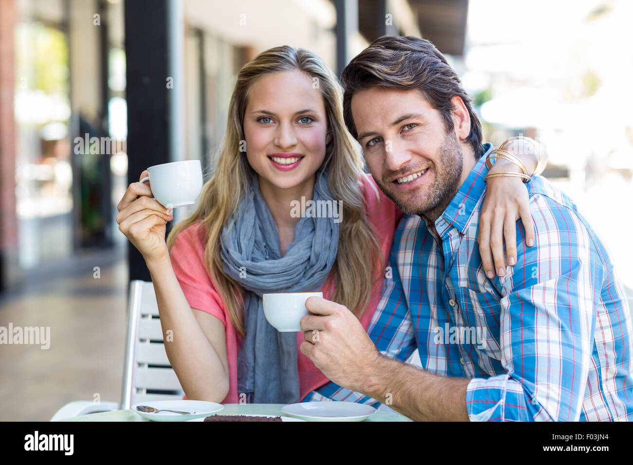Cute couple having coffee together Stock Photo - Alamy