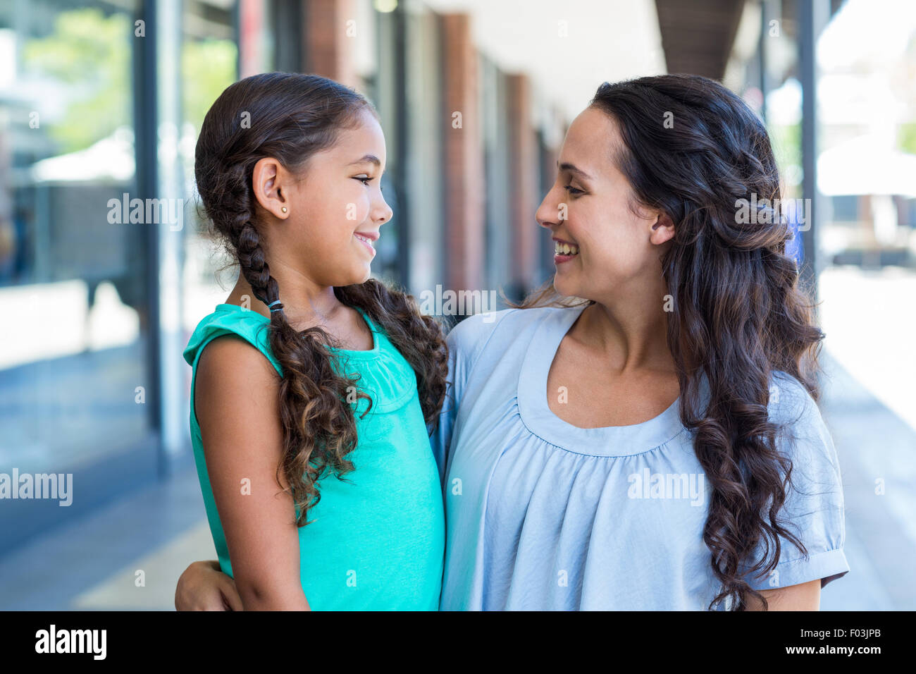 A mother and her daughter smiling at each other Stock Photo - Alamy