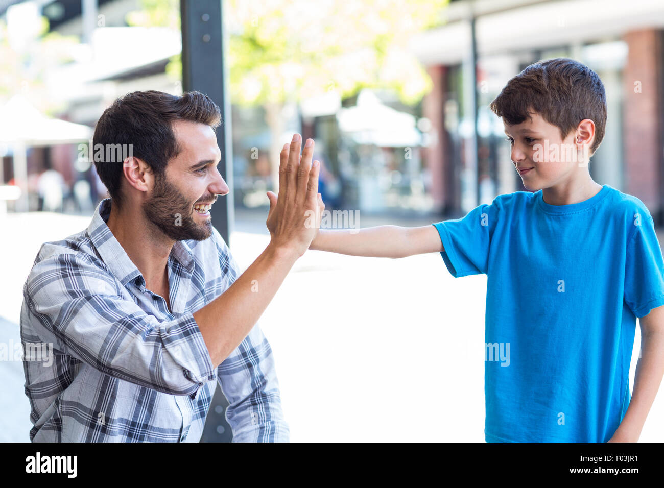 Son and father doing high five Stock Photo - Alamy