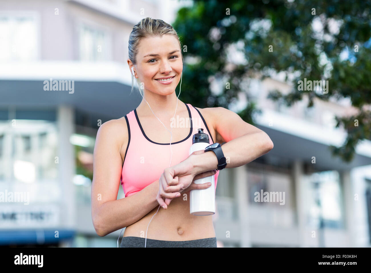 A beautiful athlete watching her watch Stock Photo - Alamy