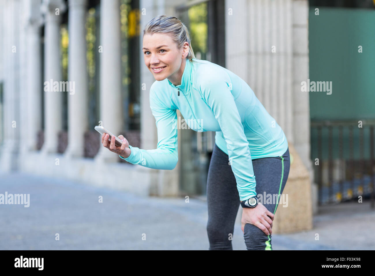 A beautiful athlete using her phone Stock Photo - Alamy