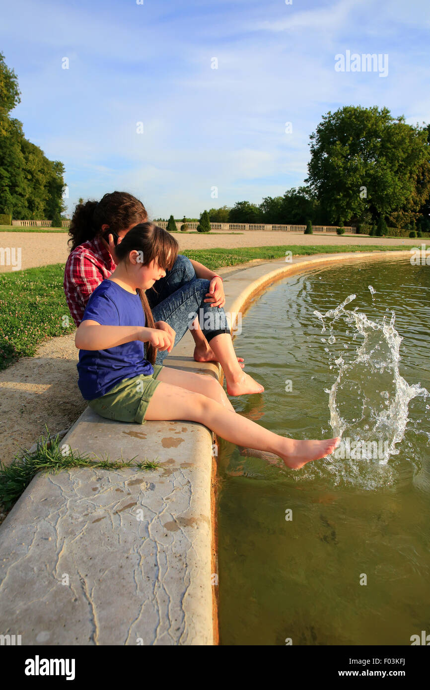 Young girls playing with the fountain hi-res stock photography and ...