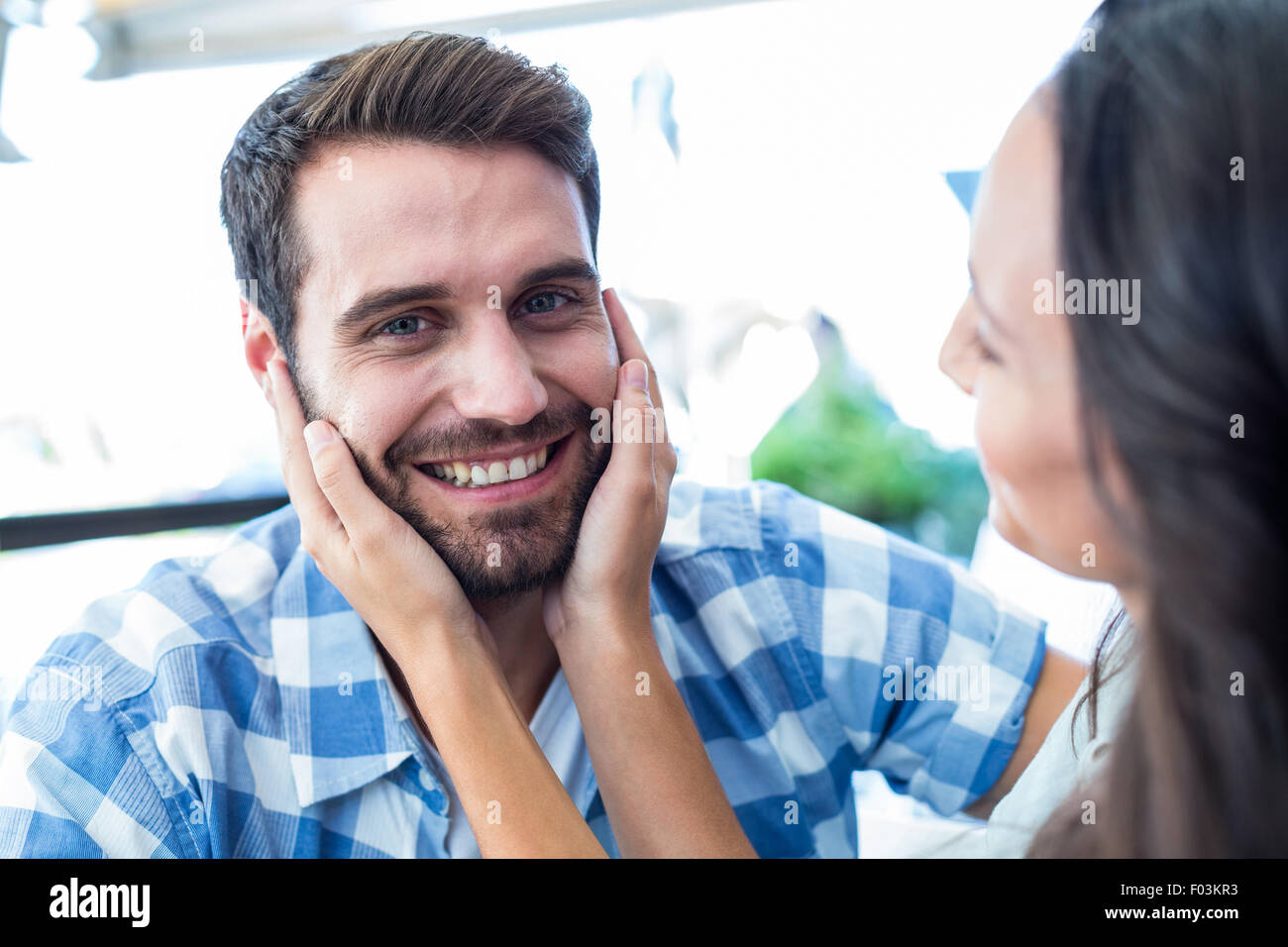 Woman touching boyfriend sitting hi-res stock photography and images ...