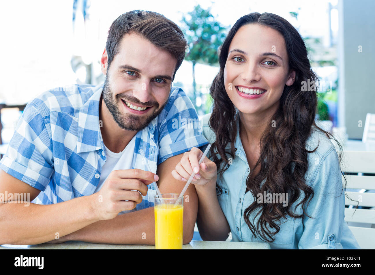 Cute couple sitting in cafe Stock Photo - Alamy