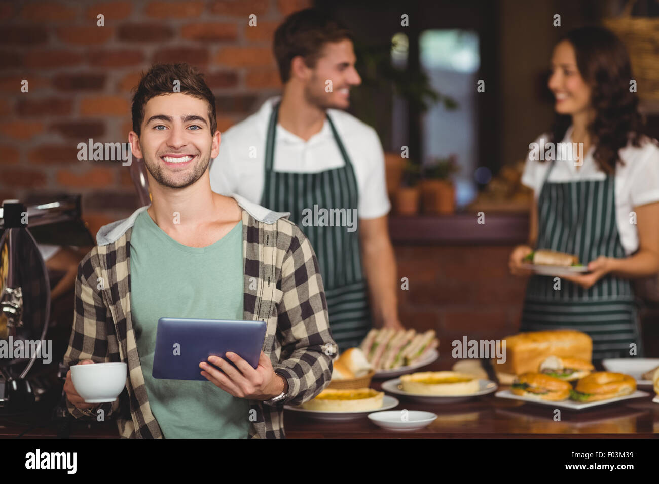 Smiling customer looking at the camera Stock Photo - Alamy