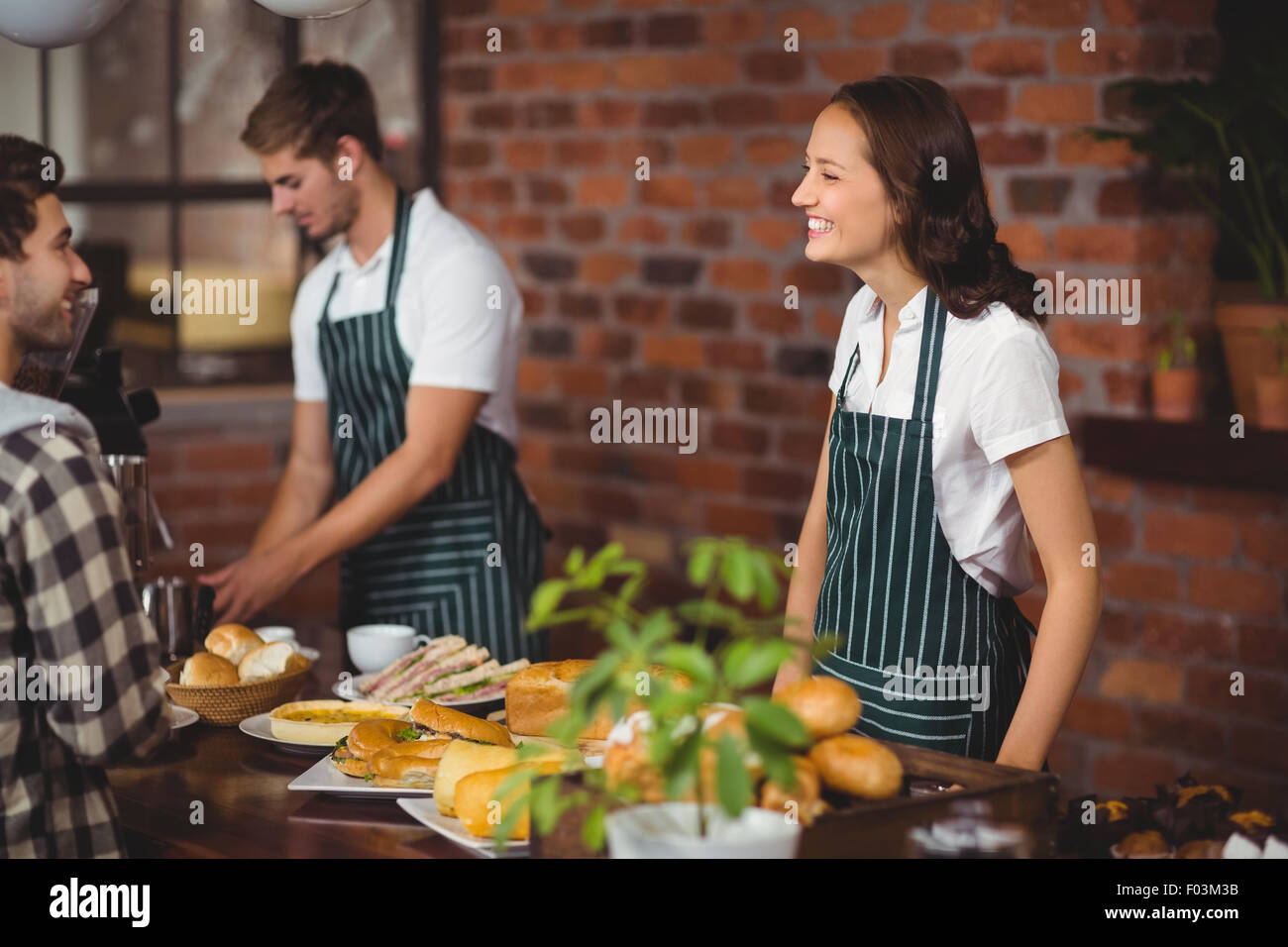 Pretty waitress talking with a customer Stock Photo - Alamy