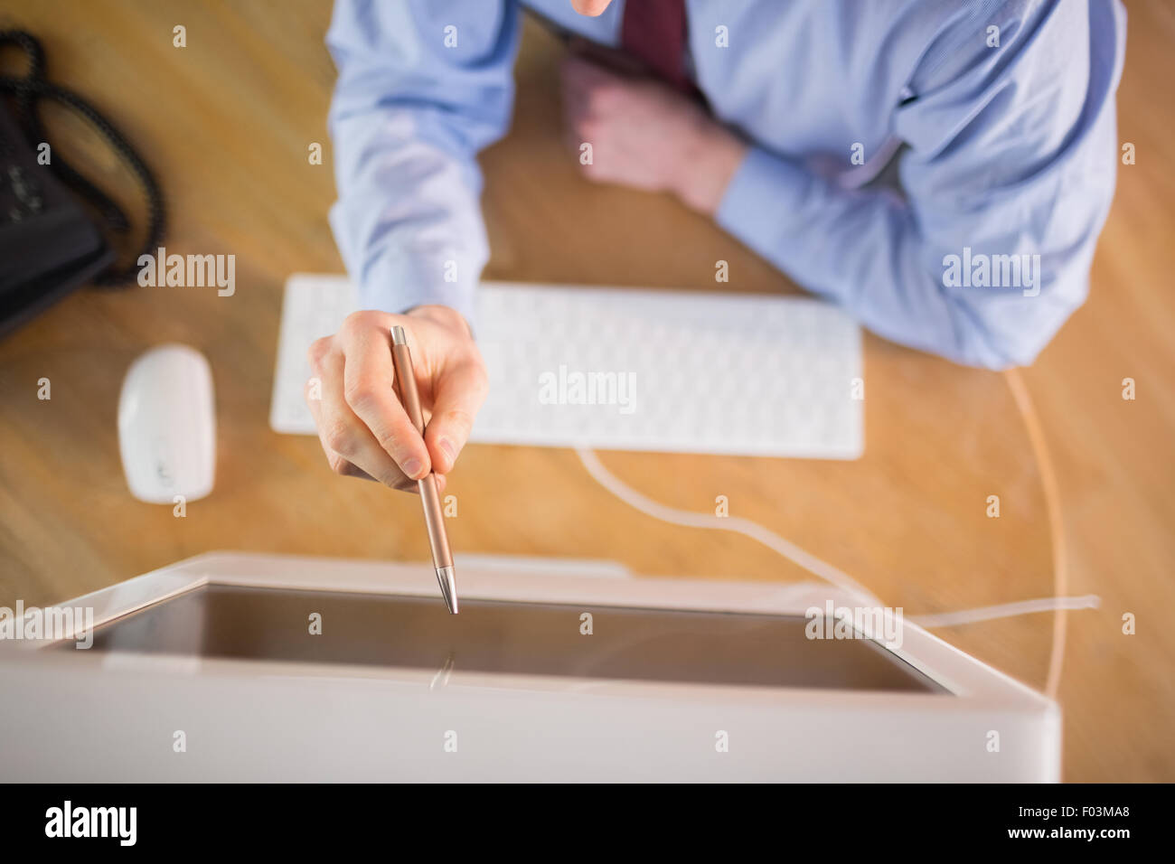 Businessman pointing to screen with pen Stock Photo - Alamy