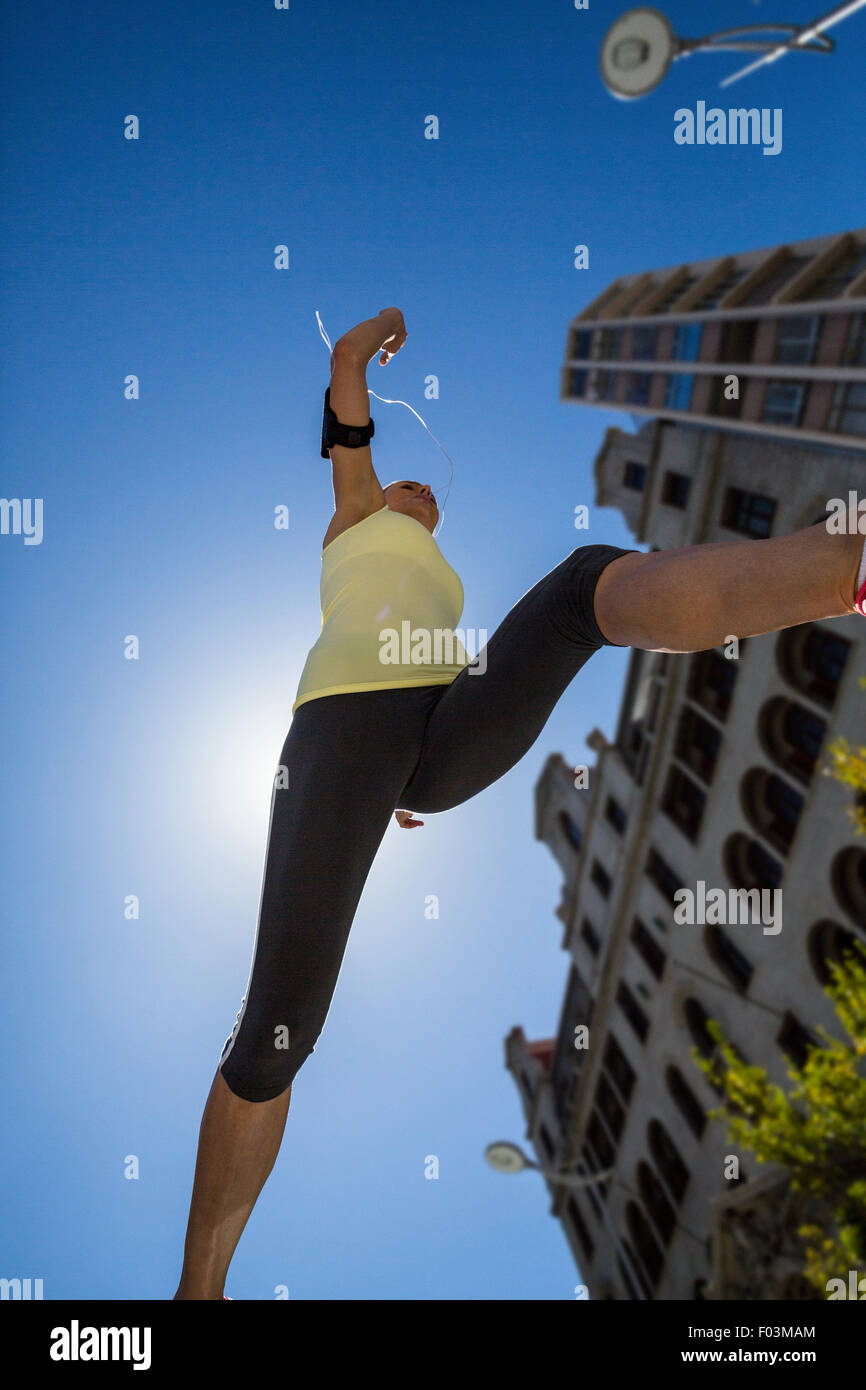 A beautiful woman jumping in the street Stock Photo - Alamy