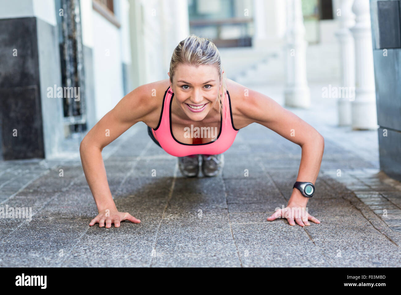 A pretty woman doing push-ups on the floor Stock Photo - Alamy