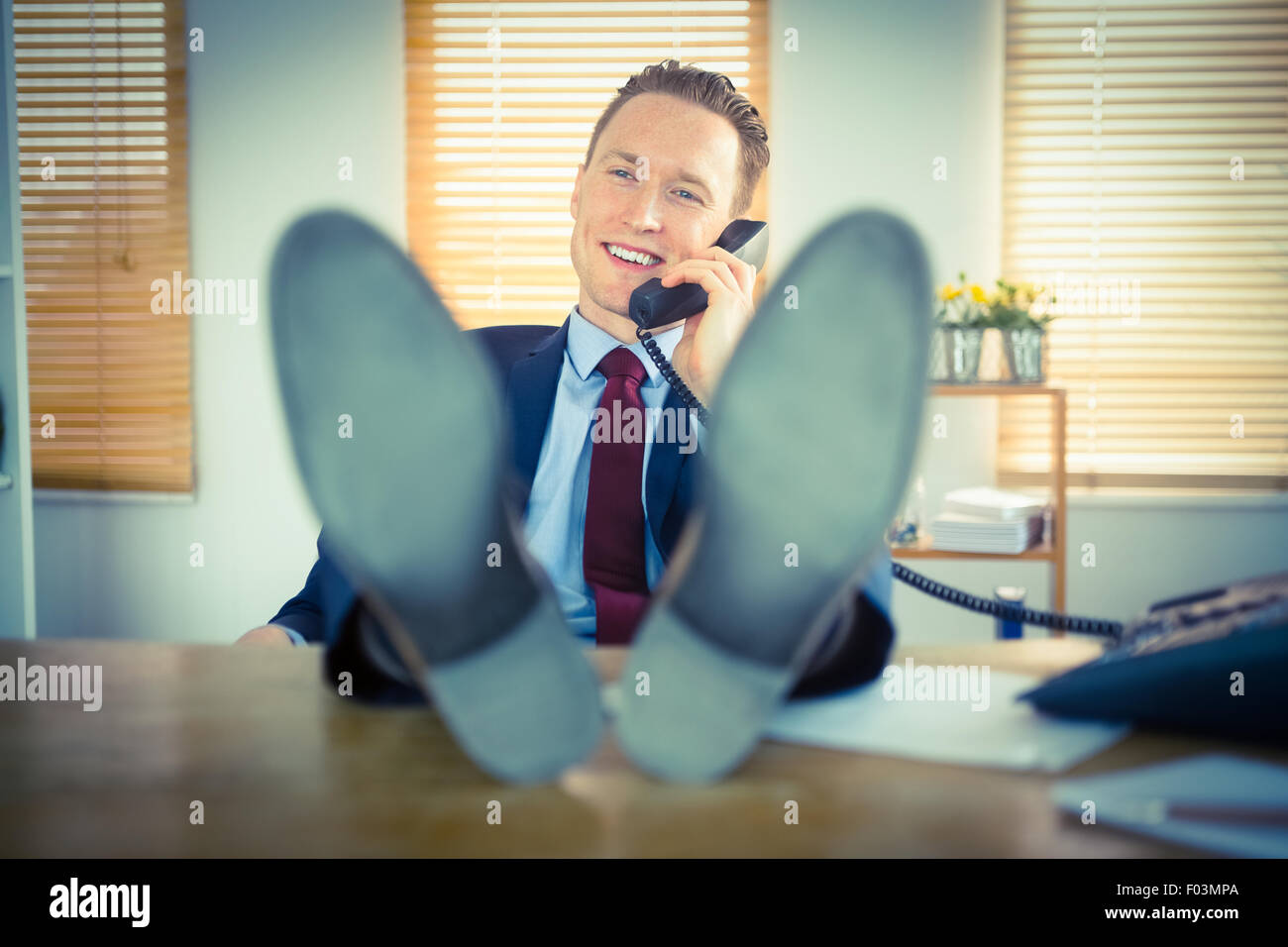 Relaxed businessman making a phone call Stock Photo - Alamy
