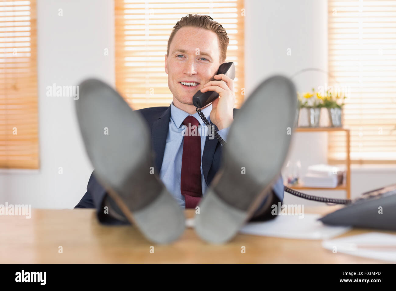 Relaxed businessman making a phone call Stock Photo - Alamy
