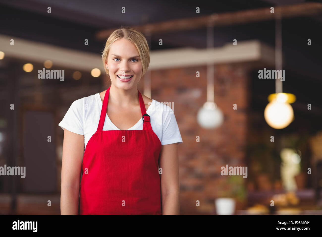 Pretty waitress looking at the camera Stock Photo - Alamy
