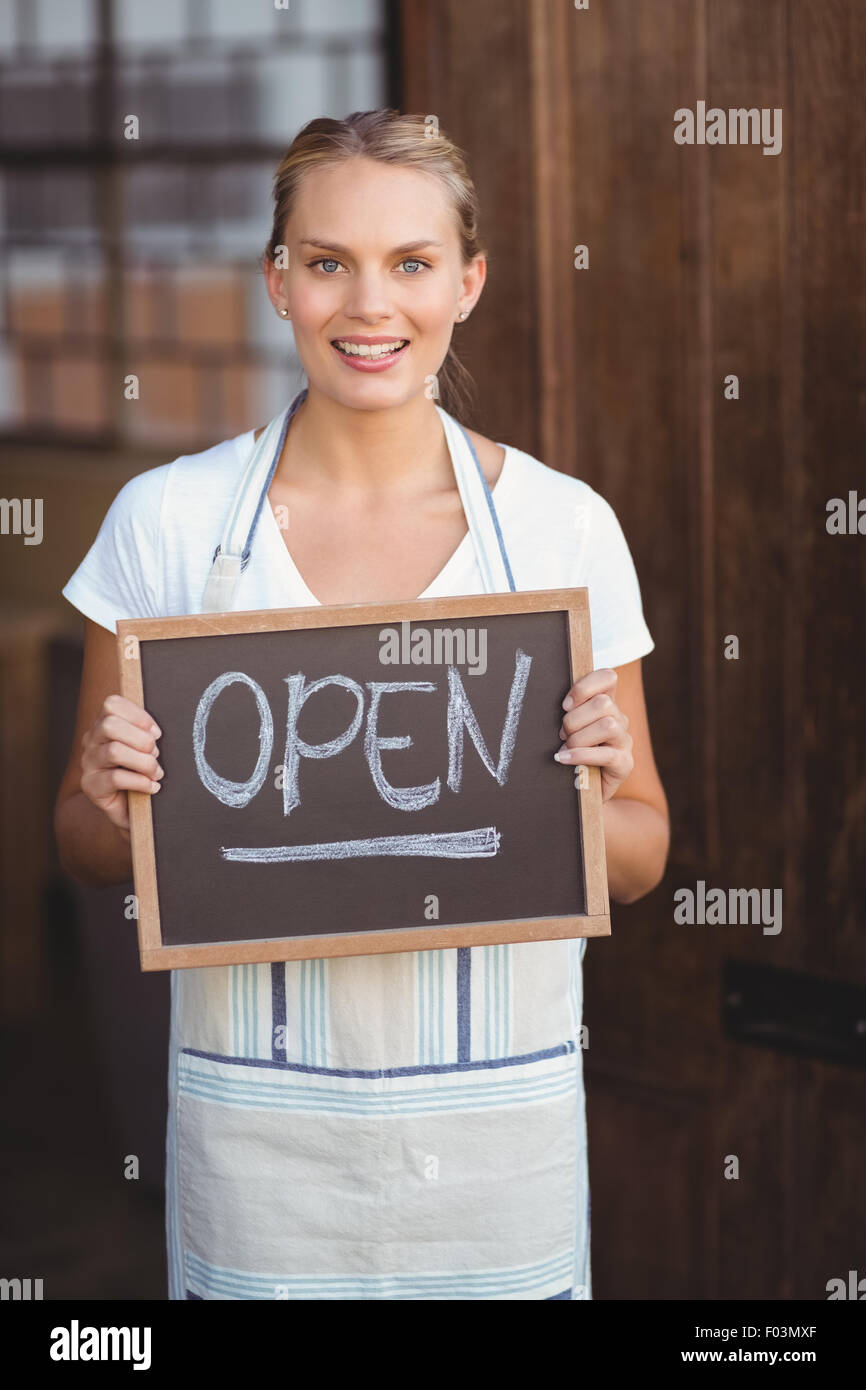 Pretty waitress with a chalkboard open sign Stock Photo - Alamy