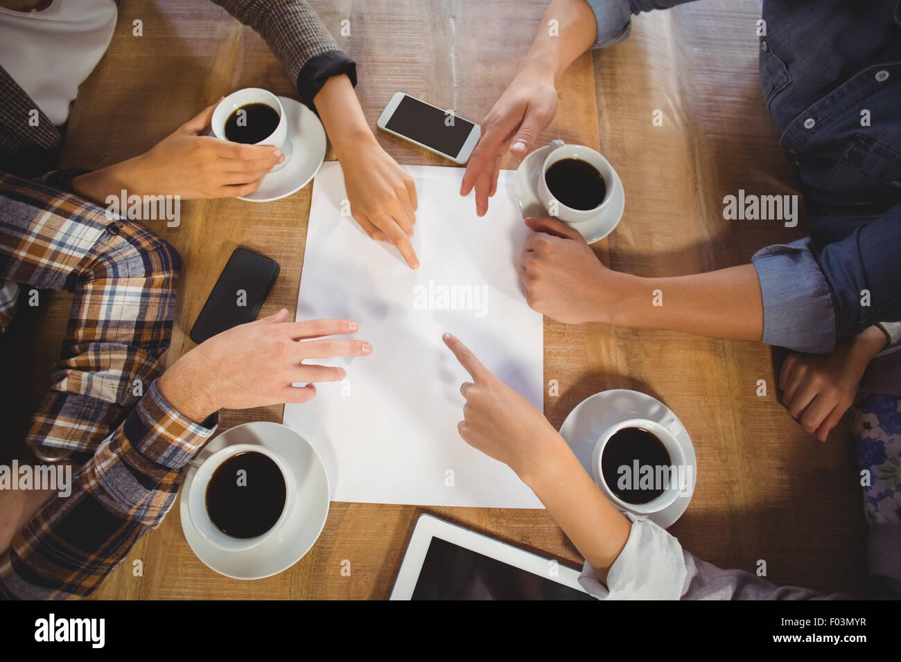 Friends discussing and drinking coffee Stock Photo - Alamy