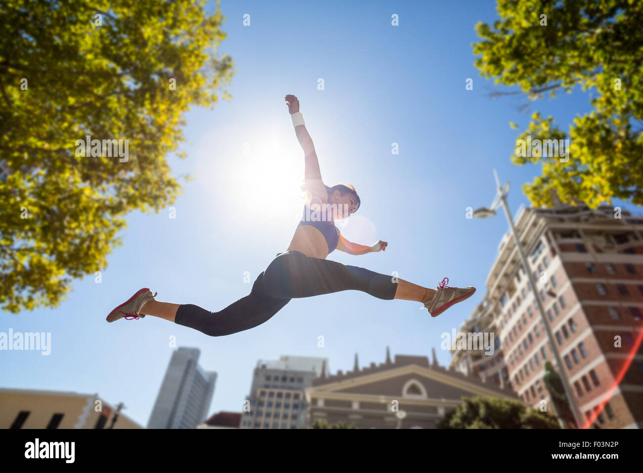 Athletic woman leaping Stock Photo - Alamy