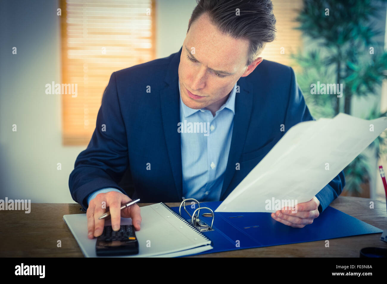 Concentrated businessman reading a document Stock Photo - Alamy