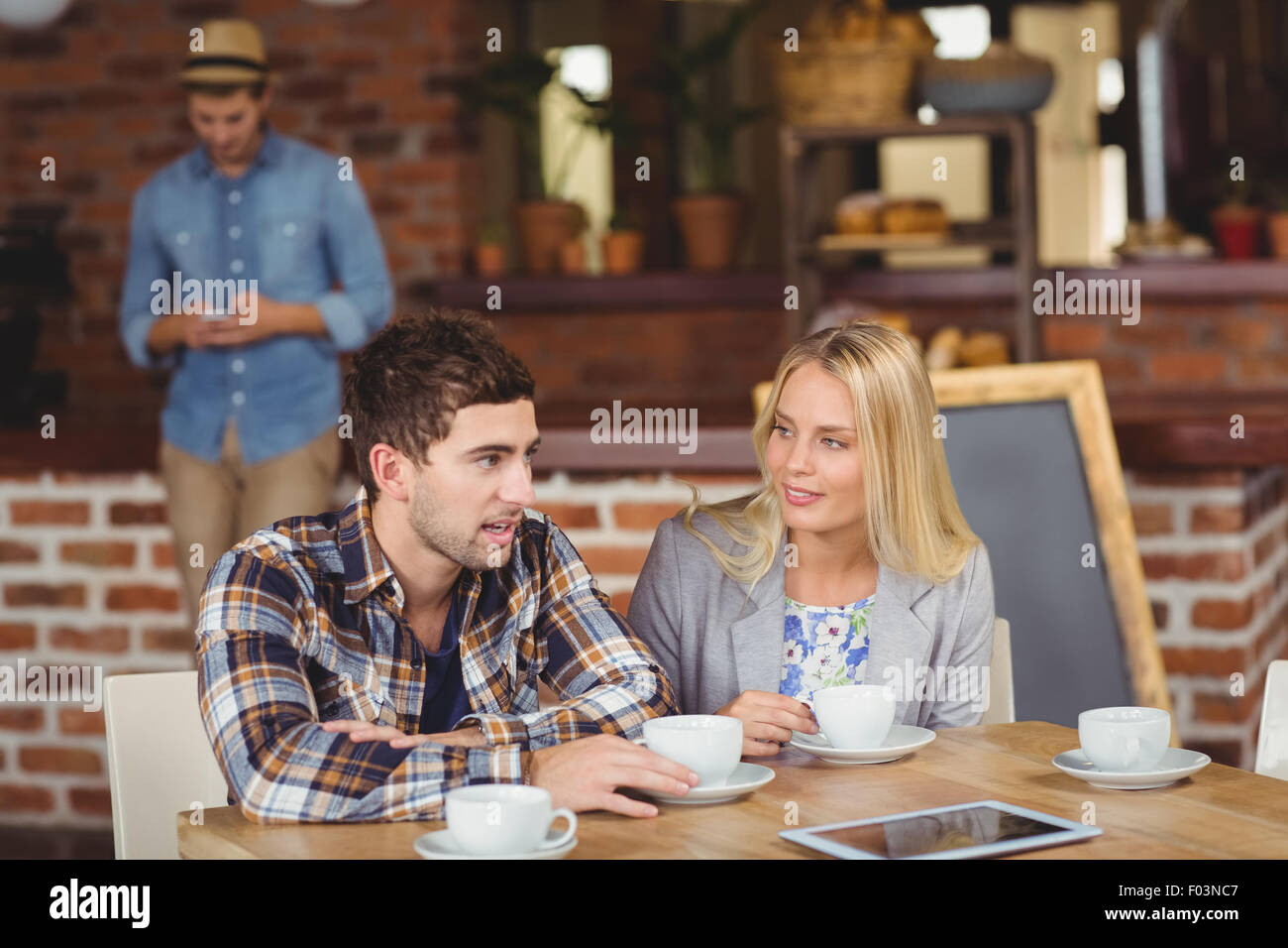 Two smiling friends talking and drinking coffee Stock Photo - Alamy