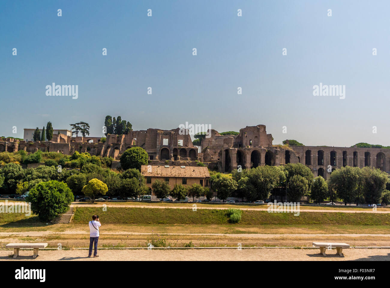 Male tourist taking a photograph or Circus Maximo and the Roman Forum ...