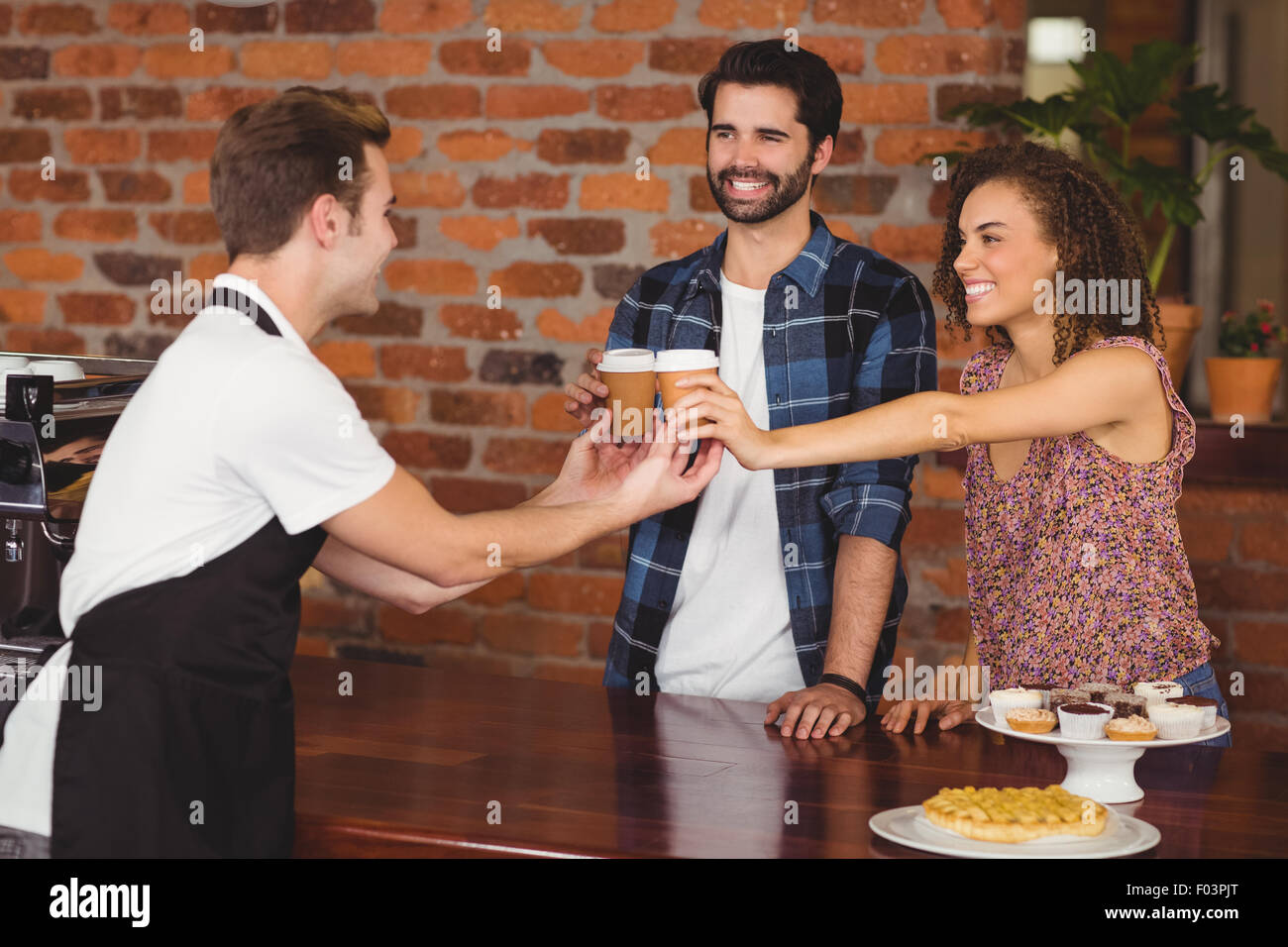 Smiling customers getting take-away cups Stock Photo - Alamy