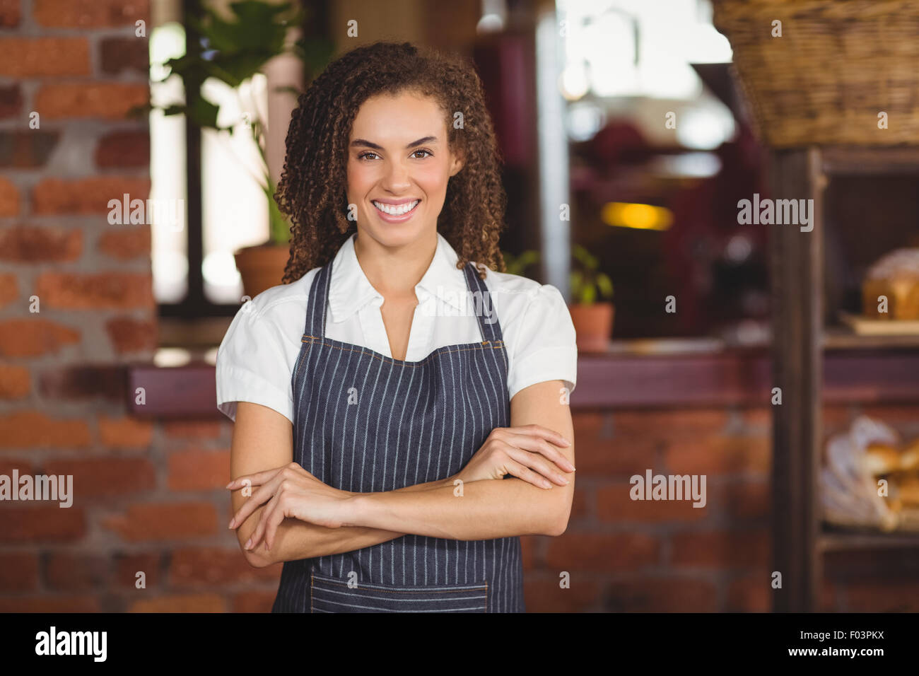 Smiling barista with arms crossed Stock Photo - Alamy