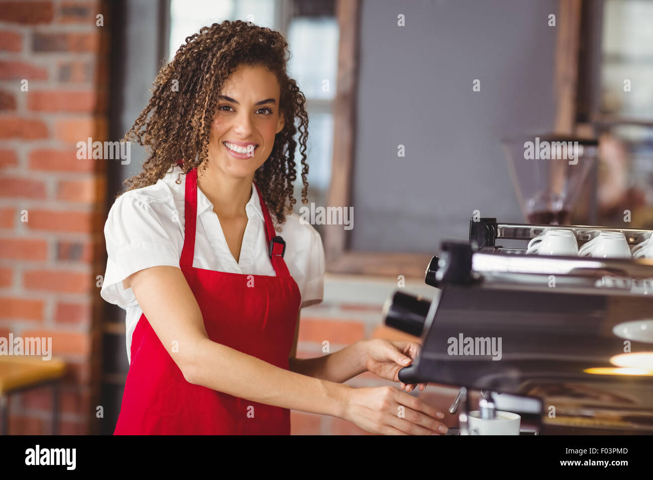 A smiling barista preparing coffee Stock Photo - Alamy