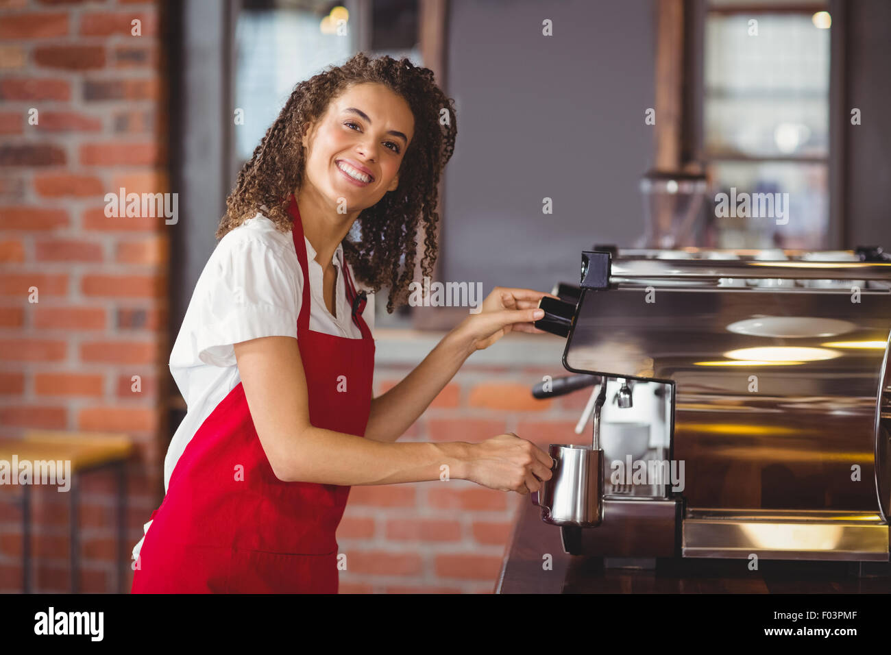 A smiling barista preparing coffee Stock Photo - Alamy