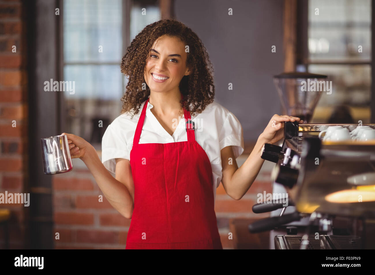 A pretty waitress holding a jug Stock Photo - Alamy