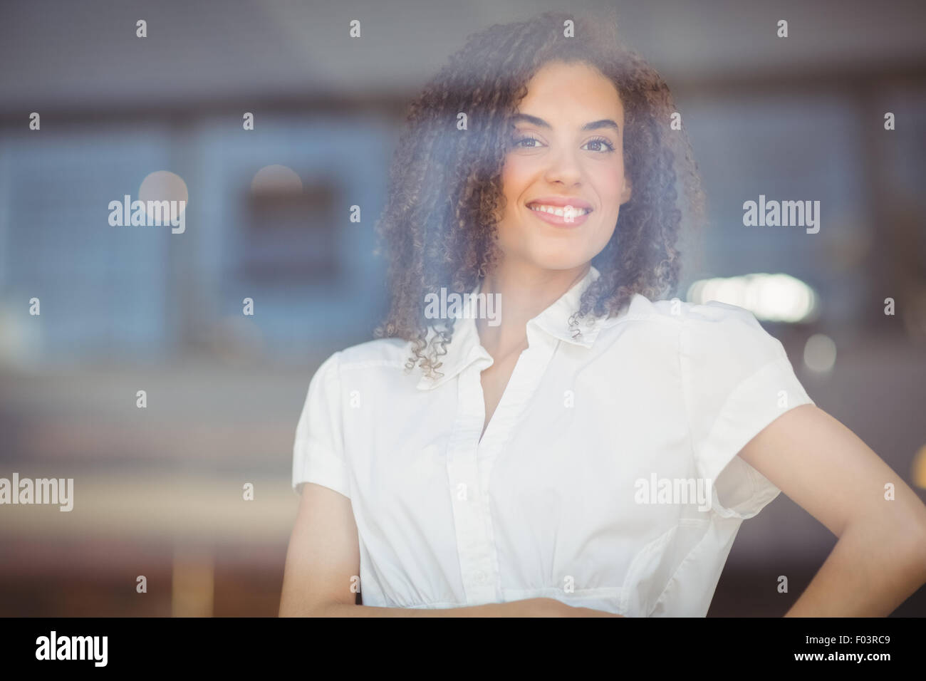 Smiling woman with hands on hips Stock Photo - Alamy