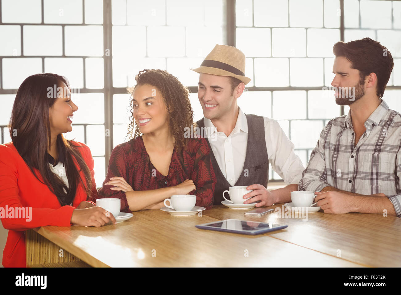 Happy friends discussing together Stock Photo - Alamy