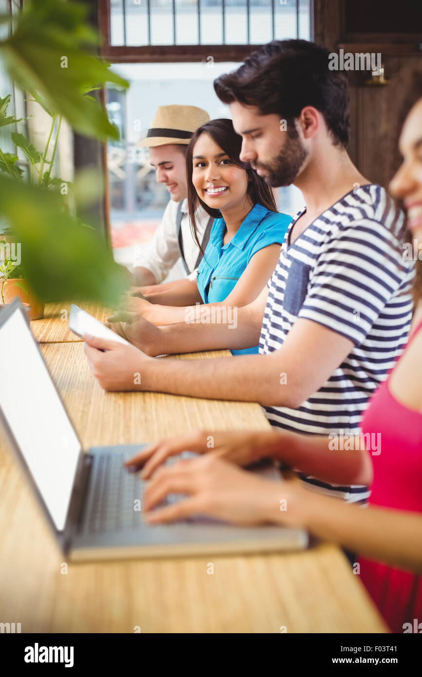 Happy friends using electronic devices Stock Photo - Alamy