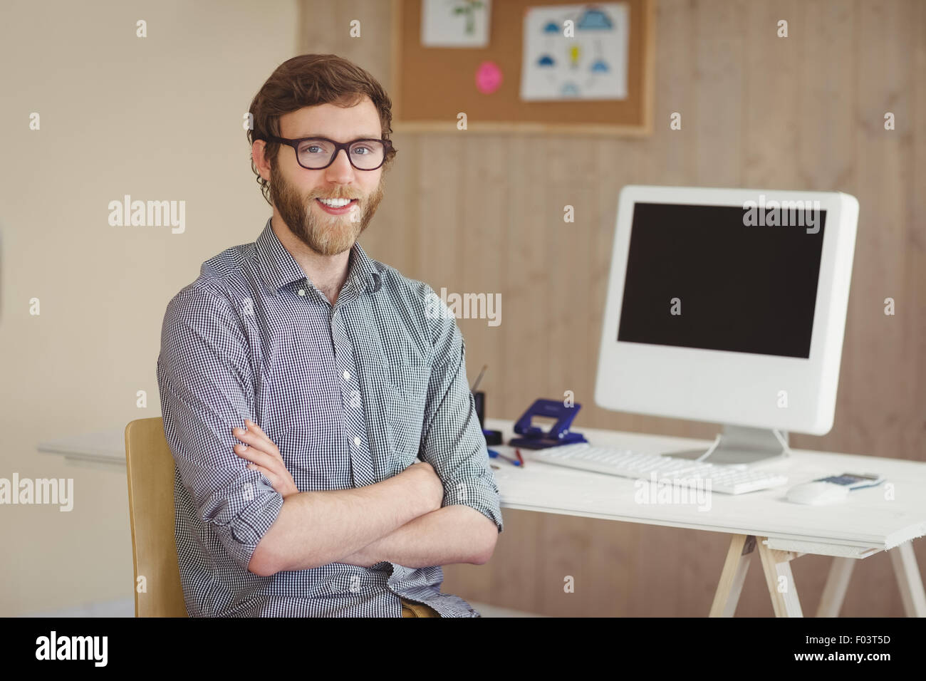 Happy hipster sitting at his desk Stock Photo - Alamy