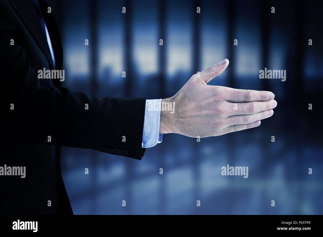 Composite image of businessman ready to shake hand Stock Photo - Alamy